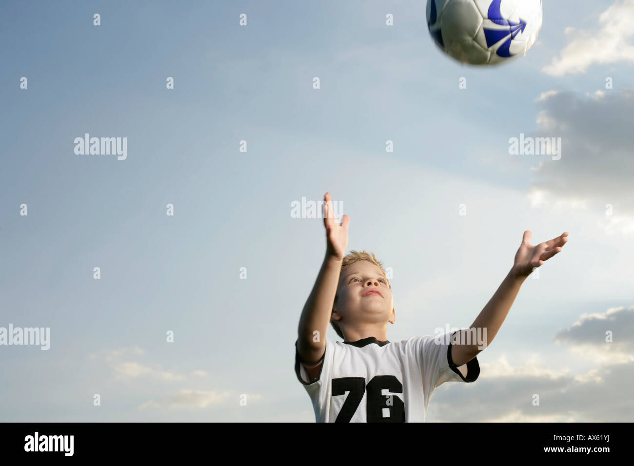 Boy catching a football Stock Photo - Alamy