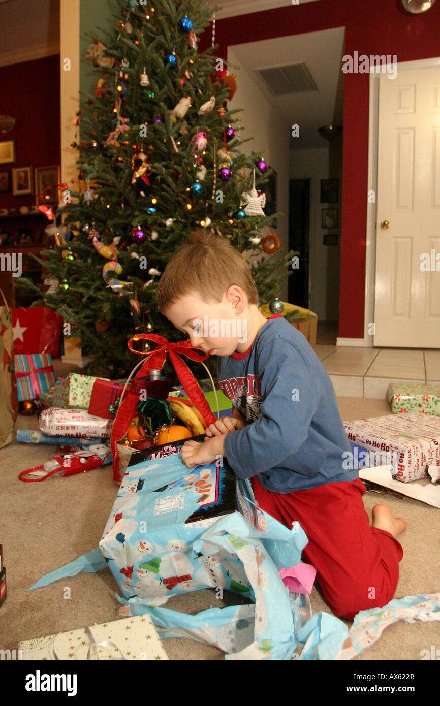 Young boy opening presents on Christmas morning Stock Photo - Alamy