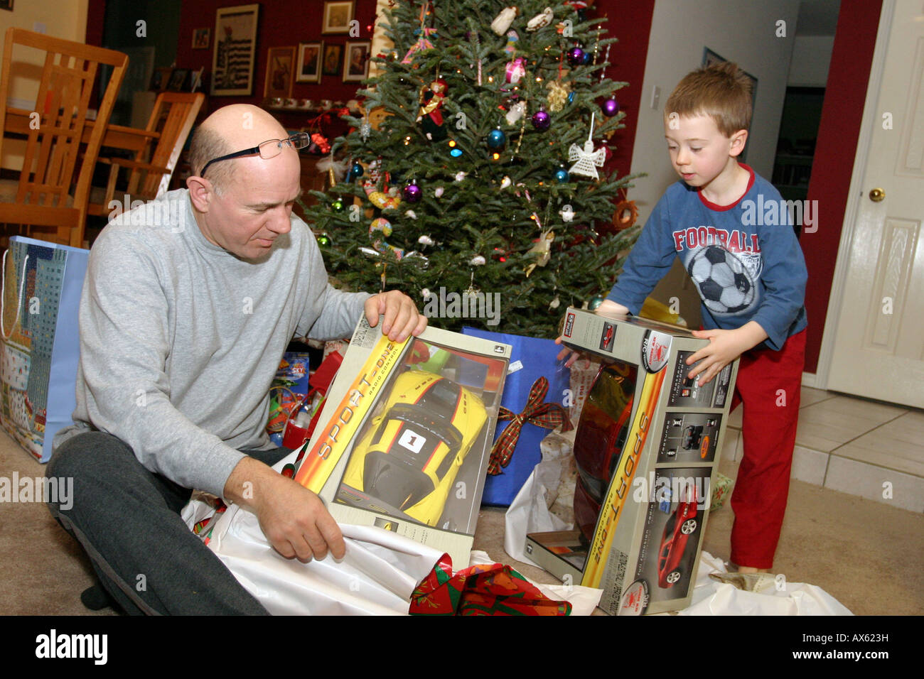 father and son opening Christmas presents on Christmas day Stock Photo ...