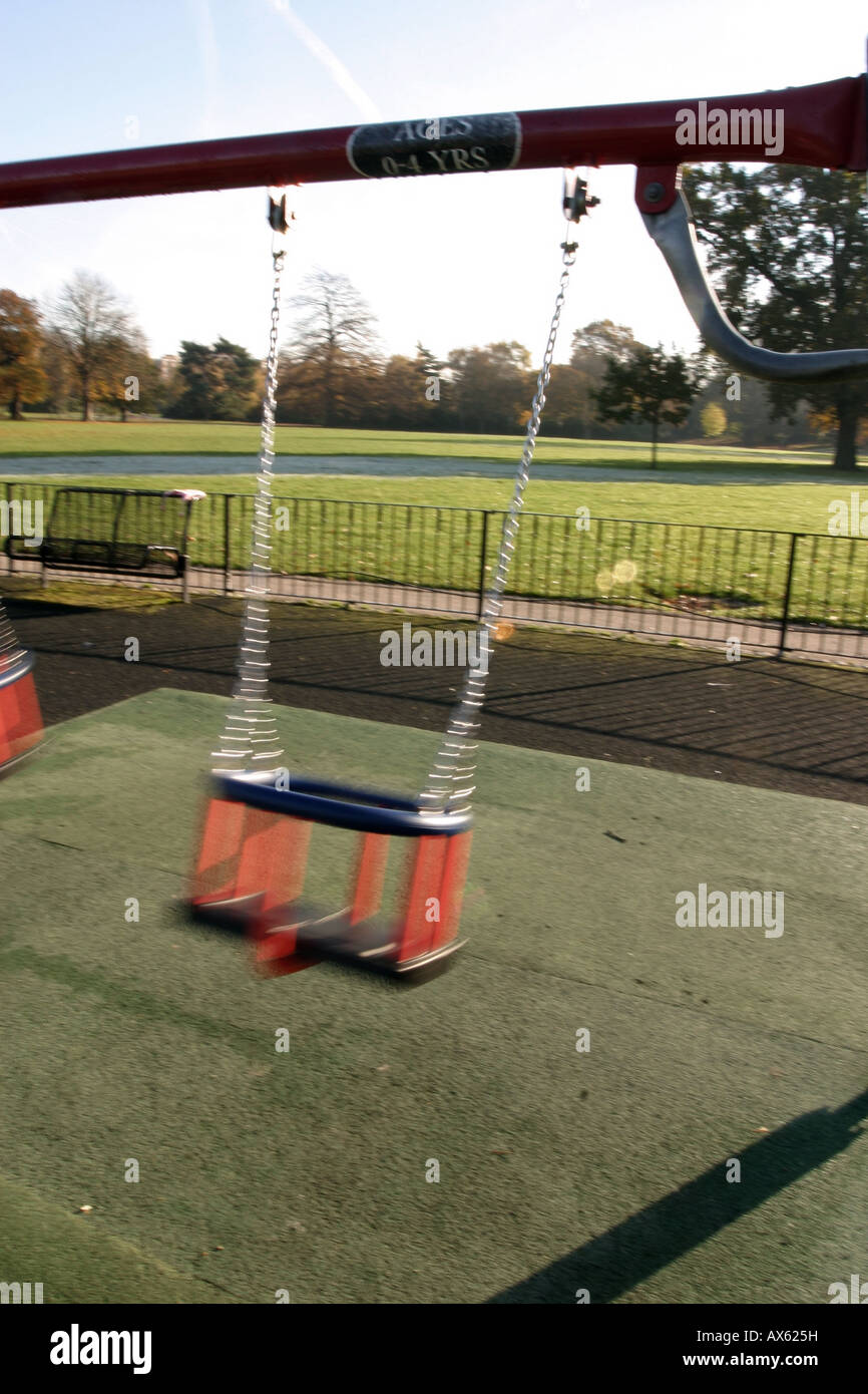 empty swing moving in the park Stock Photo - Alamy