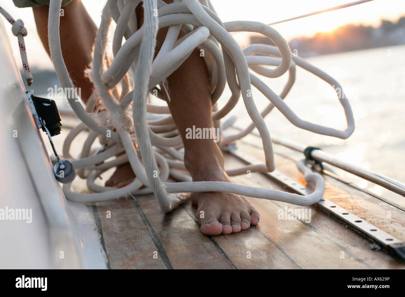 Man's foot getting entangled in a rope Stock Photo - Alamy