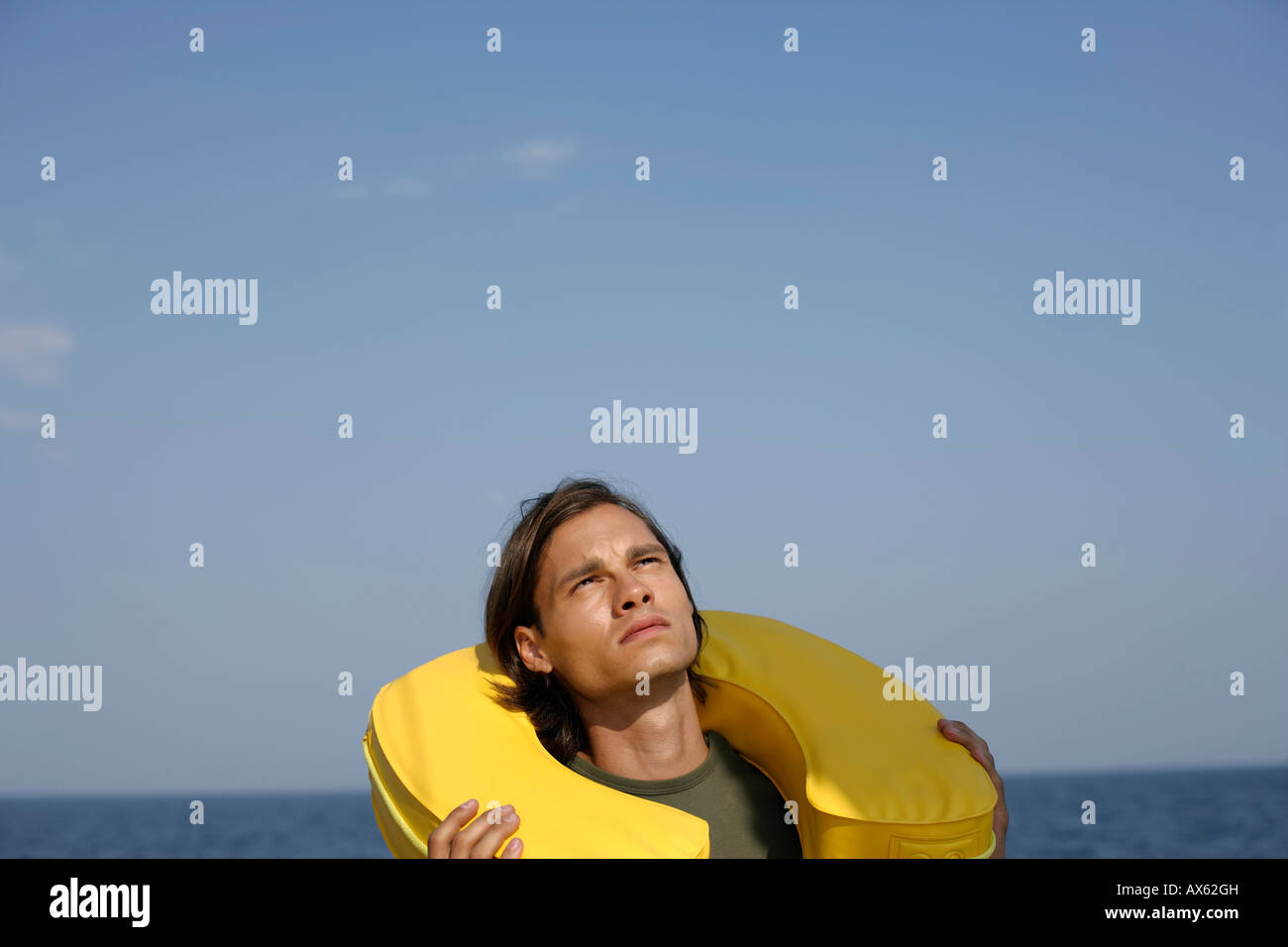 Man having a life ring on his shoulders Stock Photo - Alamy