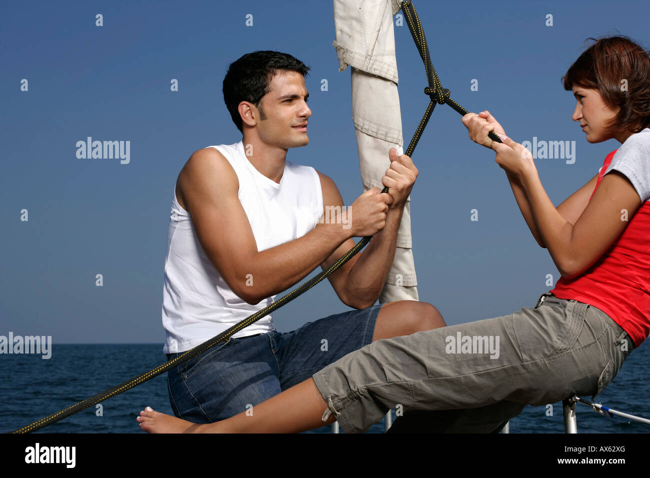 Couple pulling a rope Stock Photo - Alamy