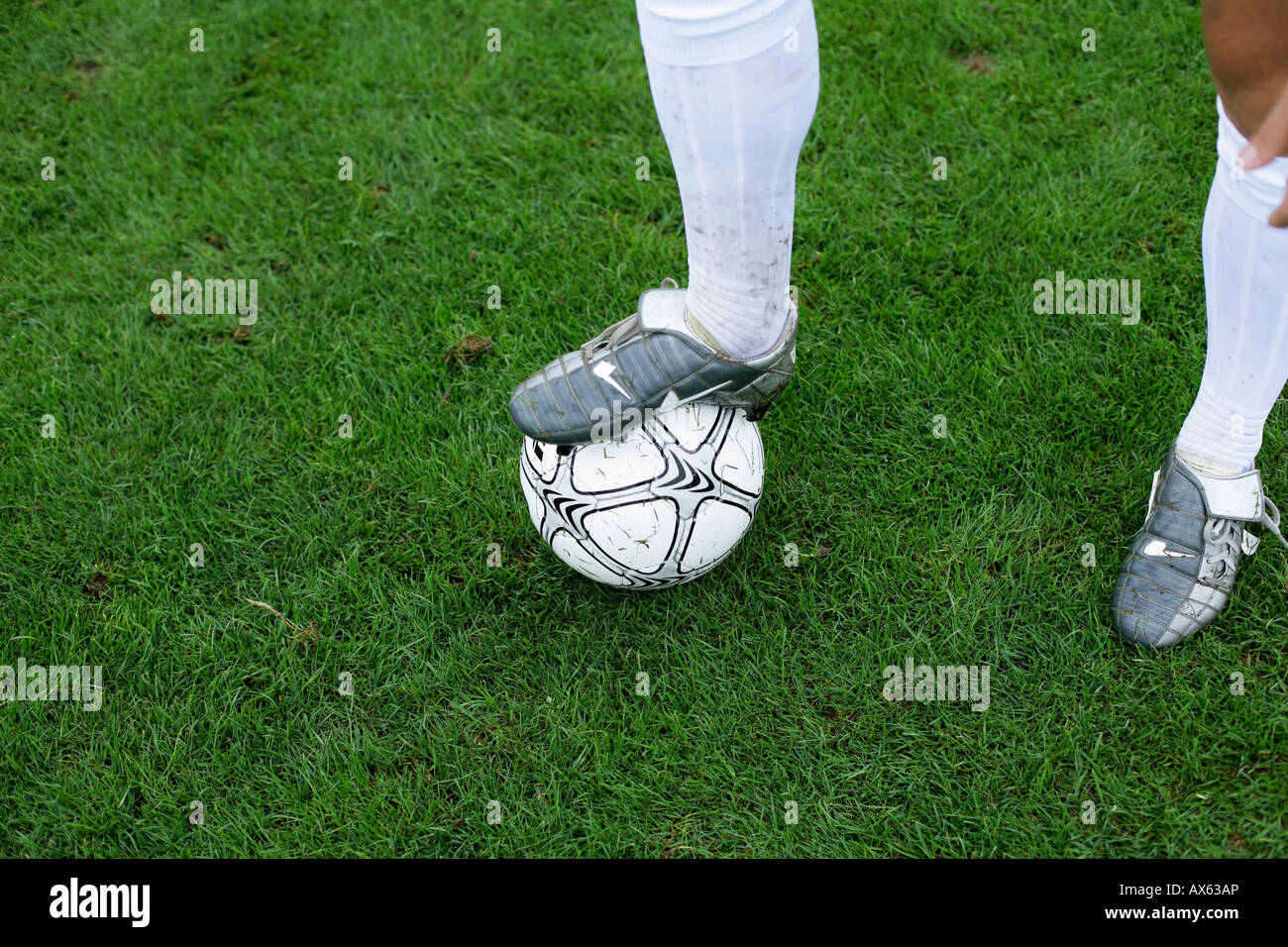 Soccer player's foot on a ball Stock Photo - Alamy