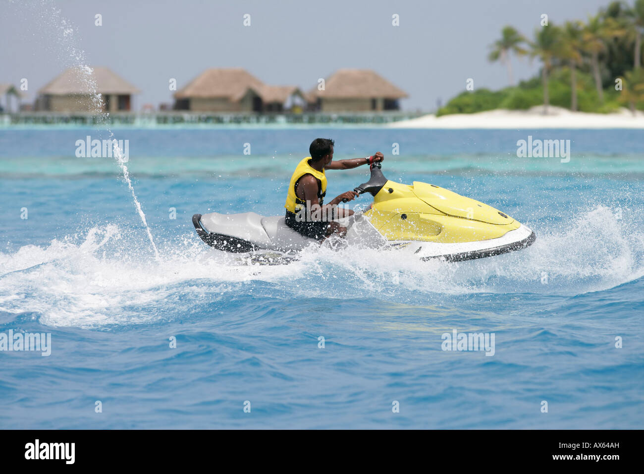 Young men using a jet ski Stock Photo - Alamy