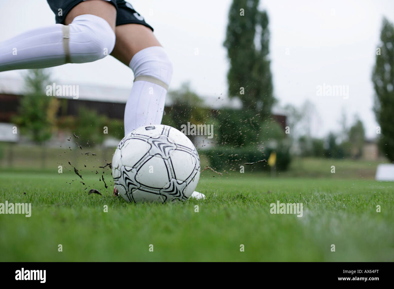 Soccer player kicking ball Stock Photo - Alamy