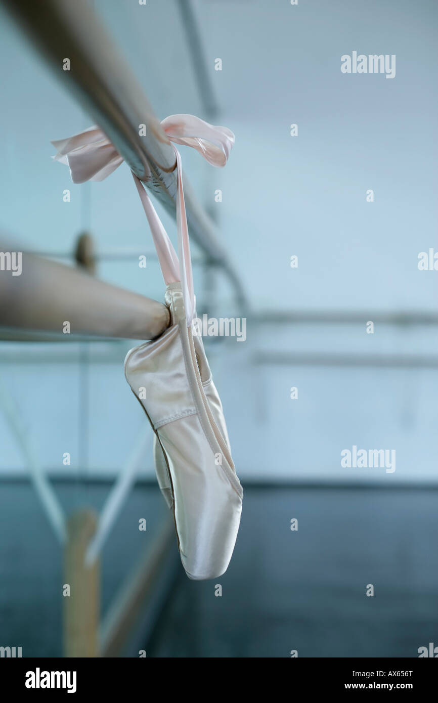 Ballet shoes hanging over a ballet bare Stock Photo - Alamy