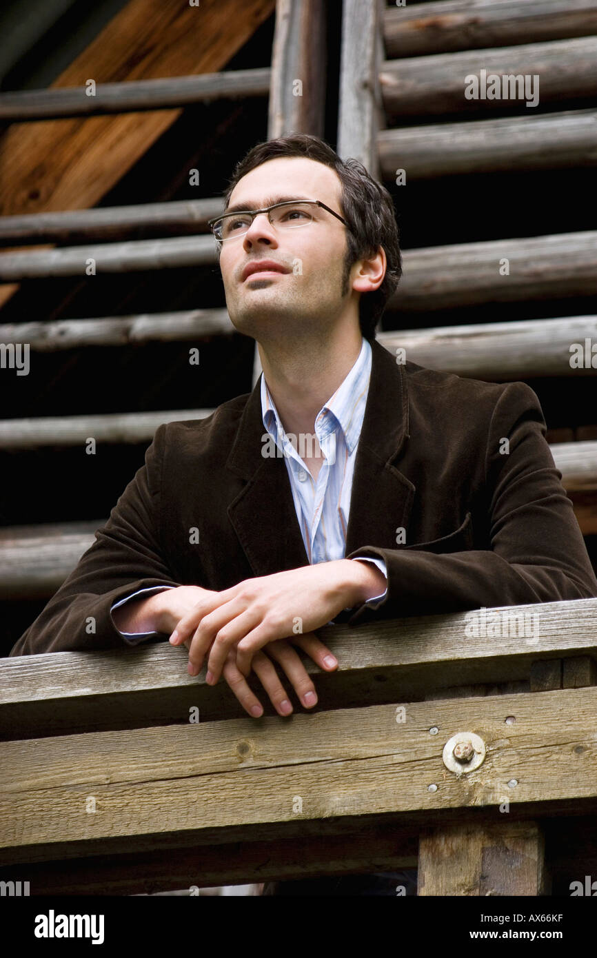 Man leaning on balustrade, portrait Stock Photo - Alamy