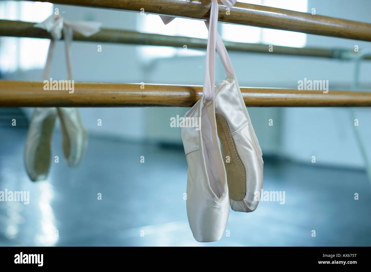 Ballet shoes hanging over a ballet bare Stock Photo - Alamy