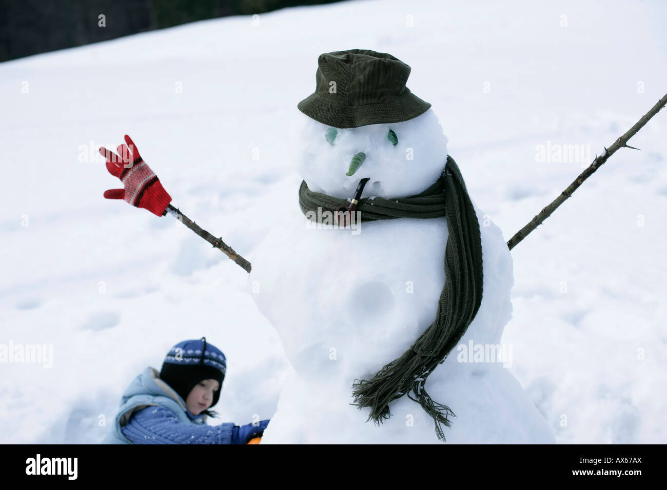 Boy making a snowman Stock Photo - Alamy