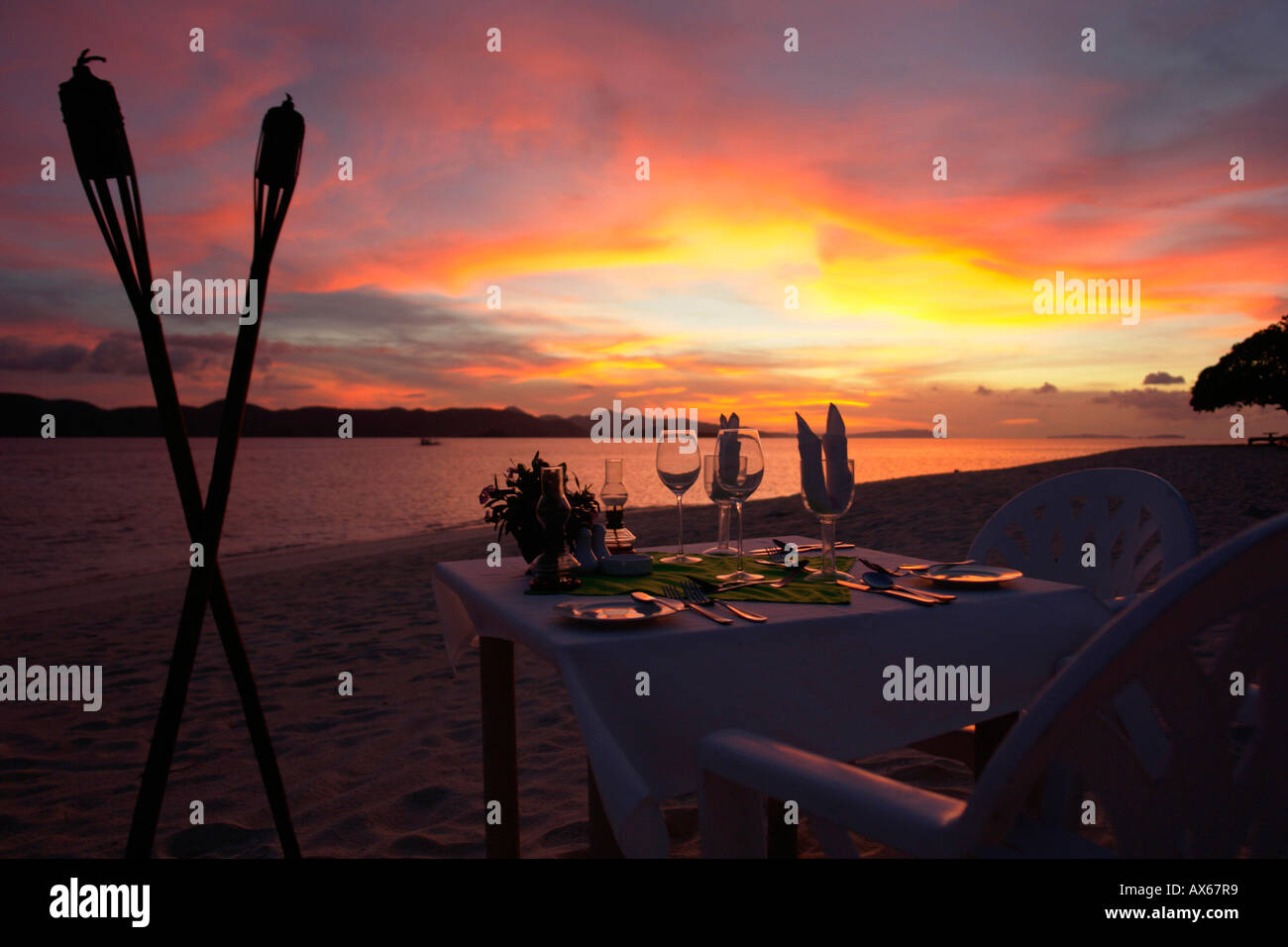 Philippines, Dining table on beach at sunset Stock Photo - Alamy
