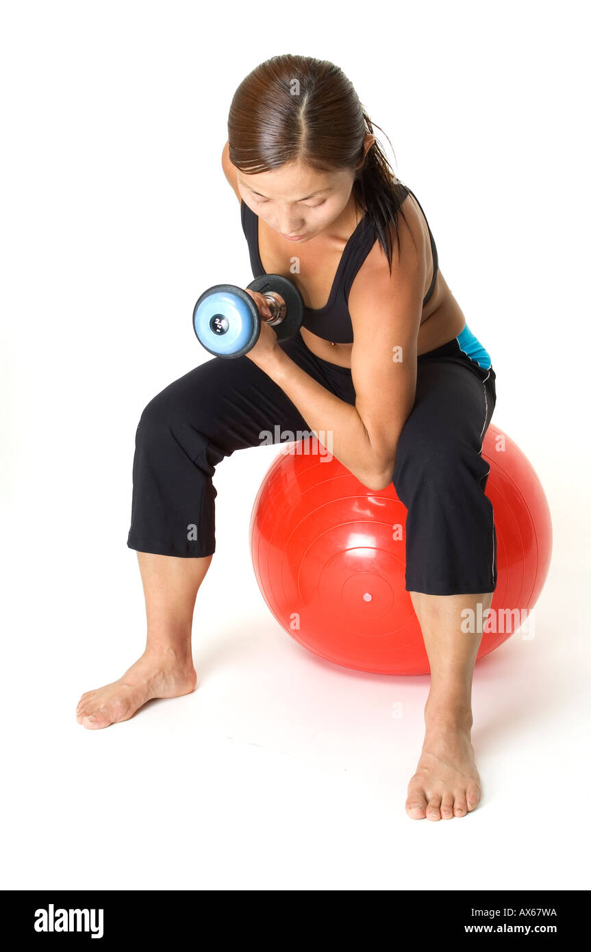 A female fitness instructor demonstrates the finishing position of a ...