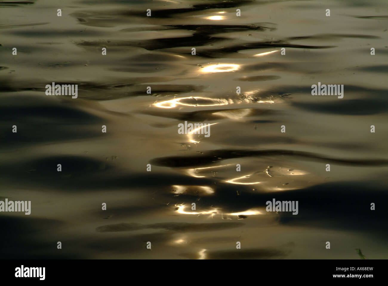 Reflection on water from the light of the setting summer sun on the ...