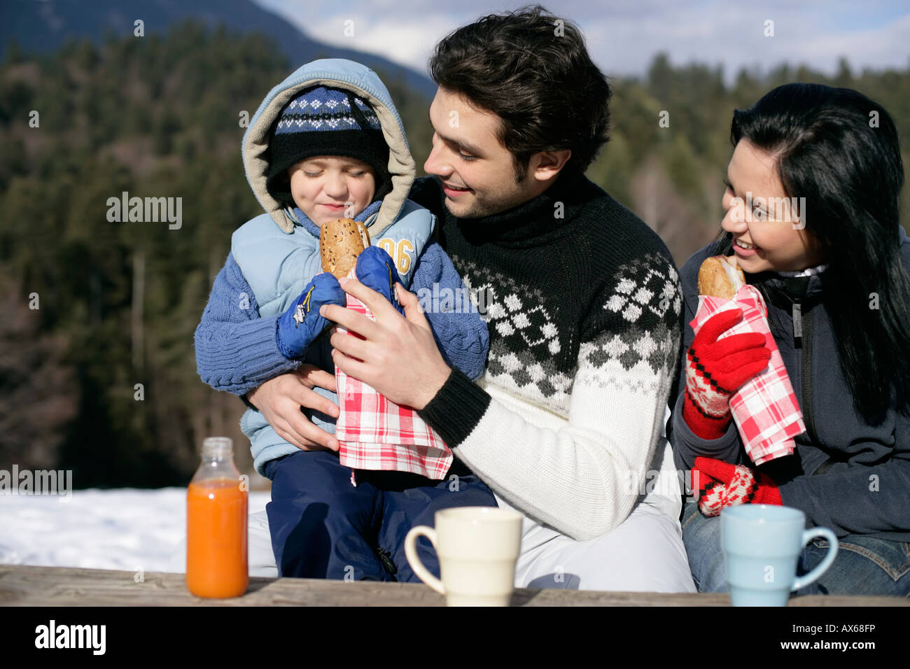 Family having a picnic in the snow Stock Photo - Alamy