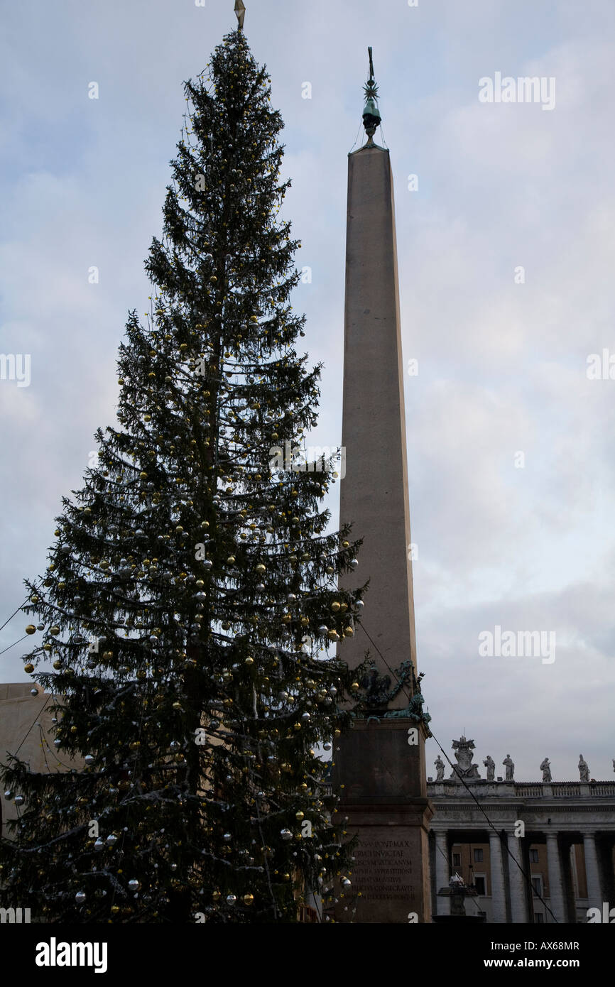 Obelisk in St. Peter's square with a christmas tree erected beside it ...