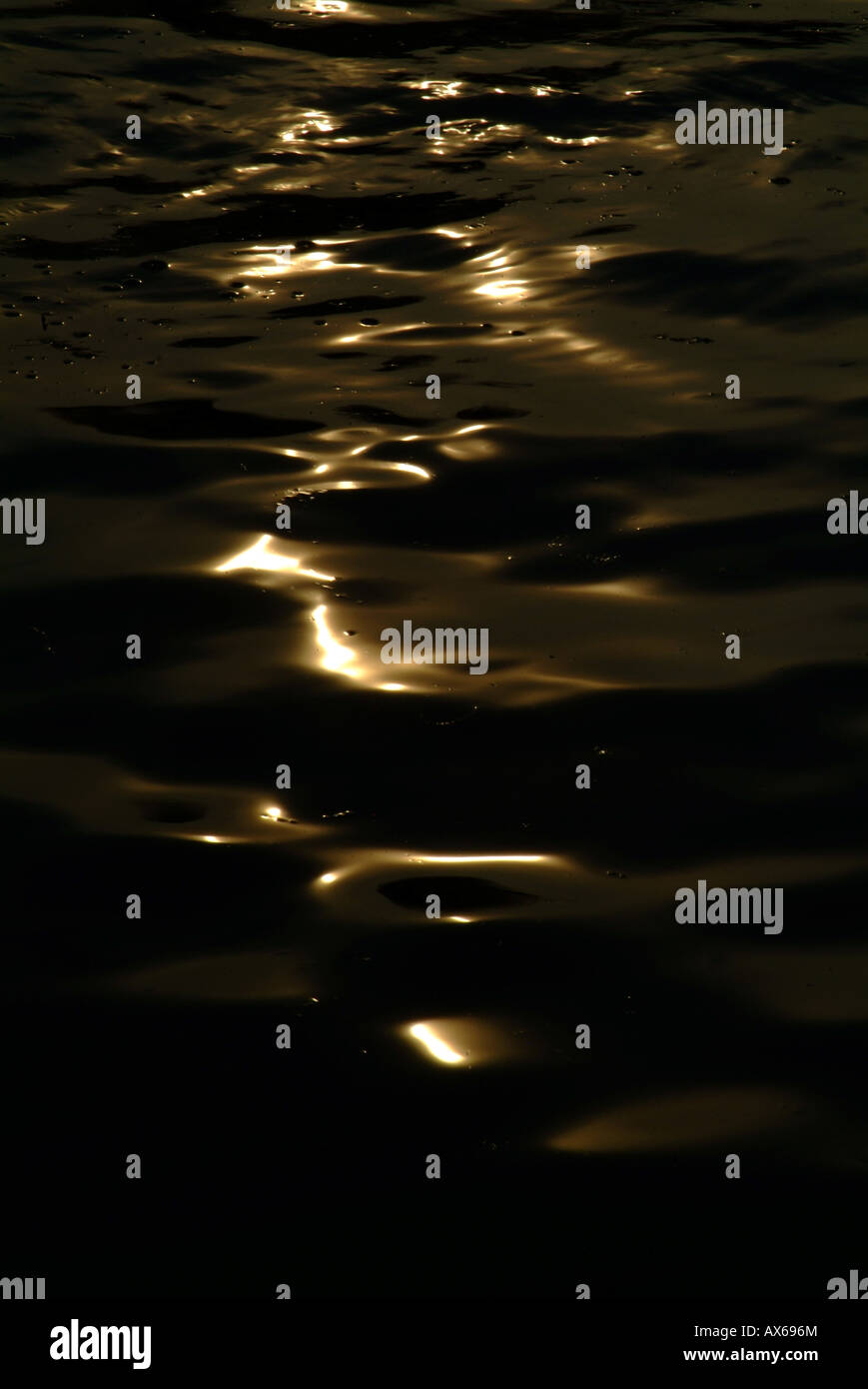Reflection on water from the light of the setting summer sun on the ...