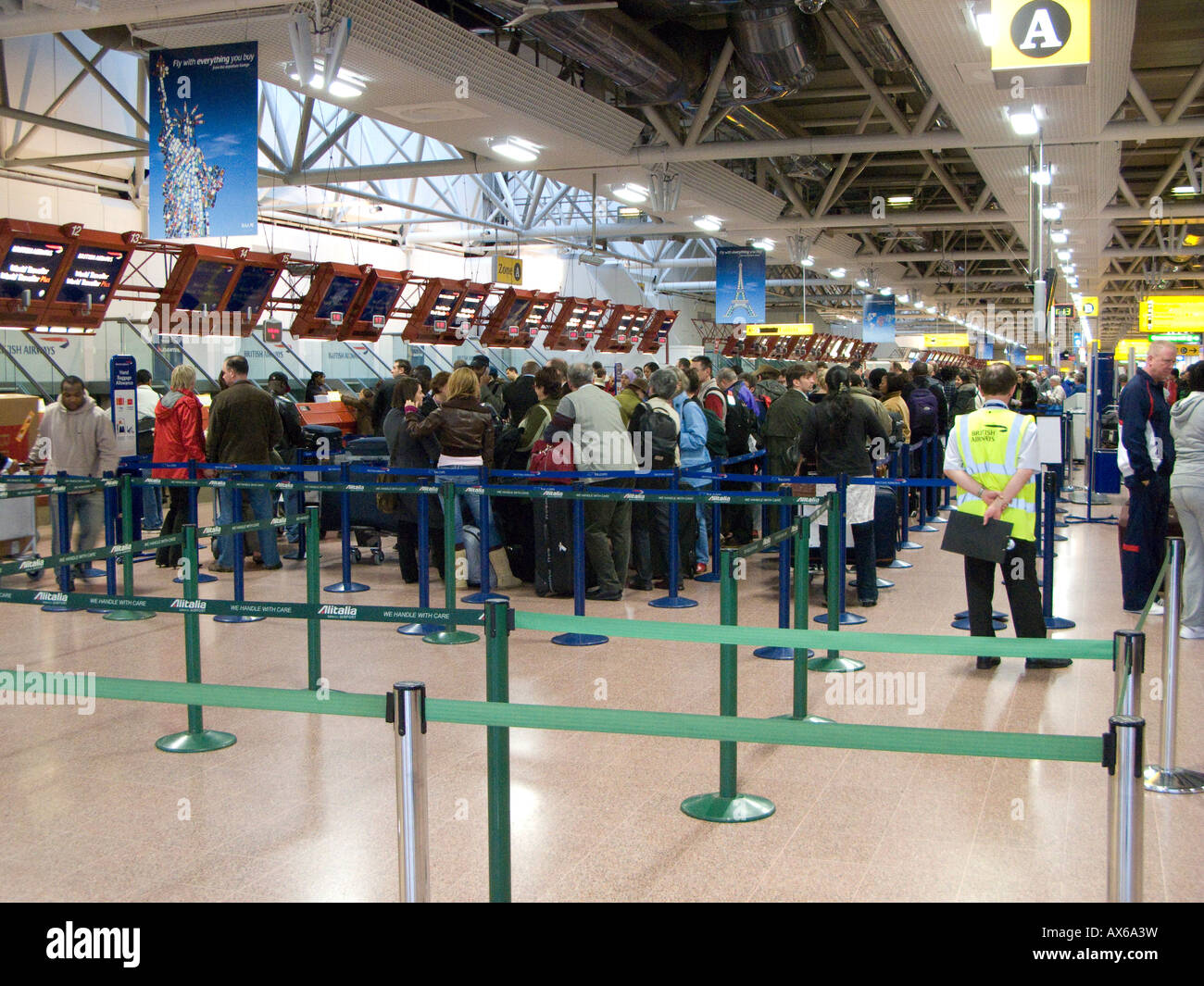 Passengers queue for their plane at Heathrow Airport Terminal 4 London ...