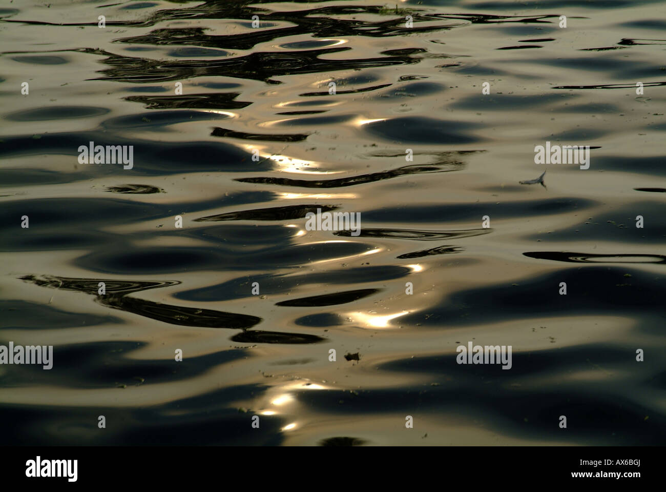 Reflection on water from the light of the setting summer sun on the ...