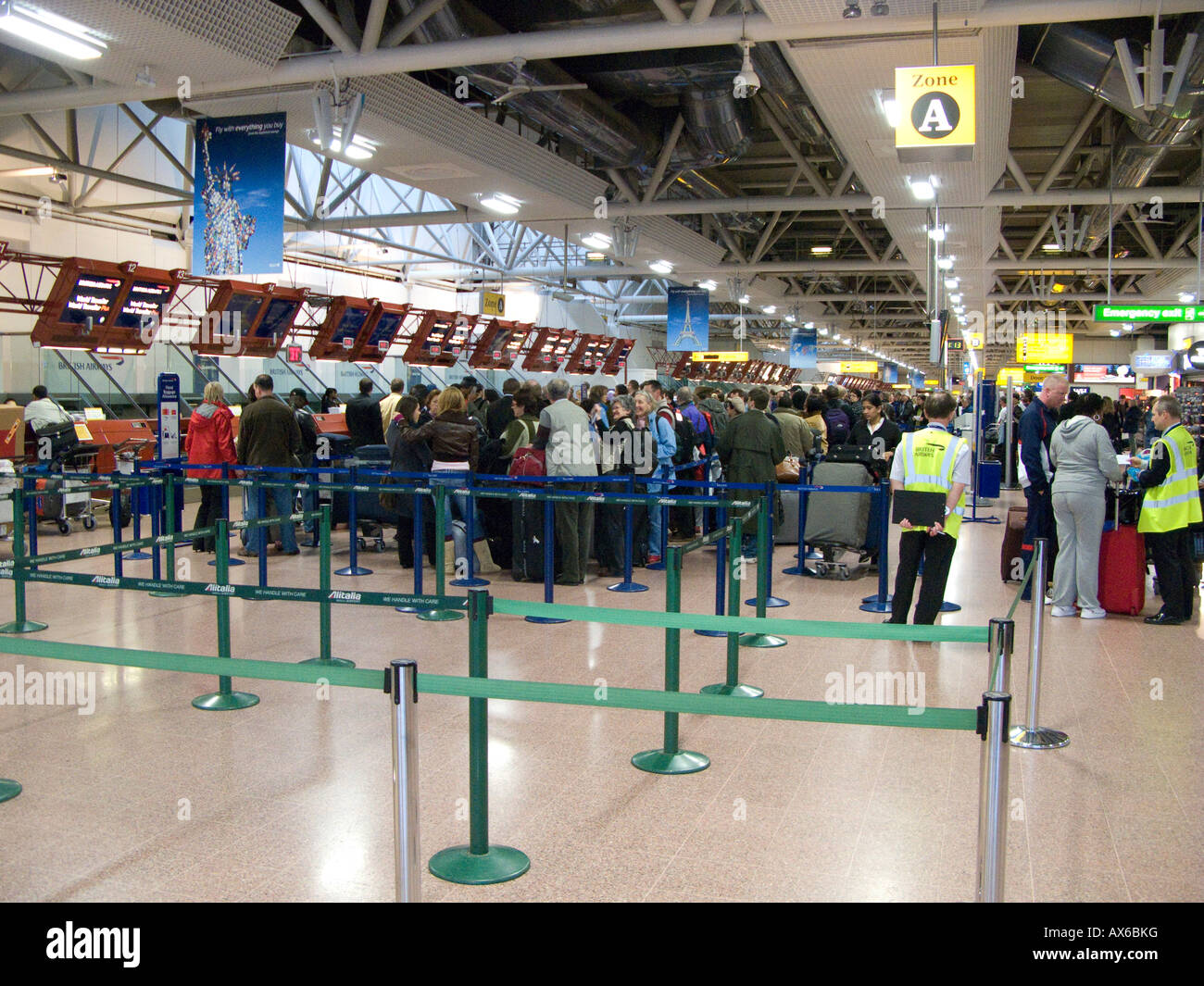 Passengers queue for their plane at Heathrow Airport Terminal 4 London ...