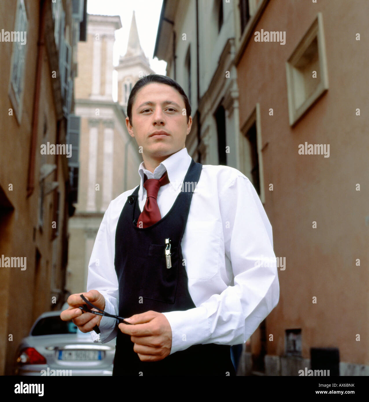 An Albanian waiter standing in the street working at a restaurant in ...