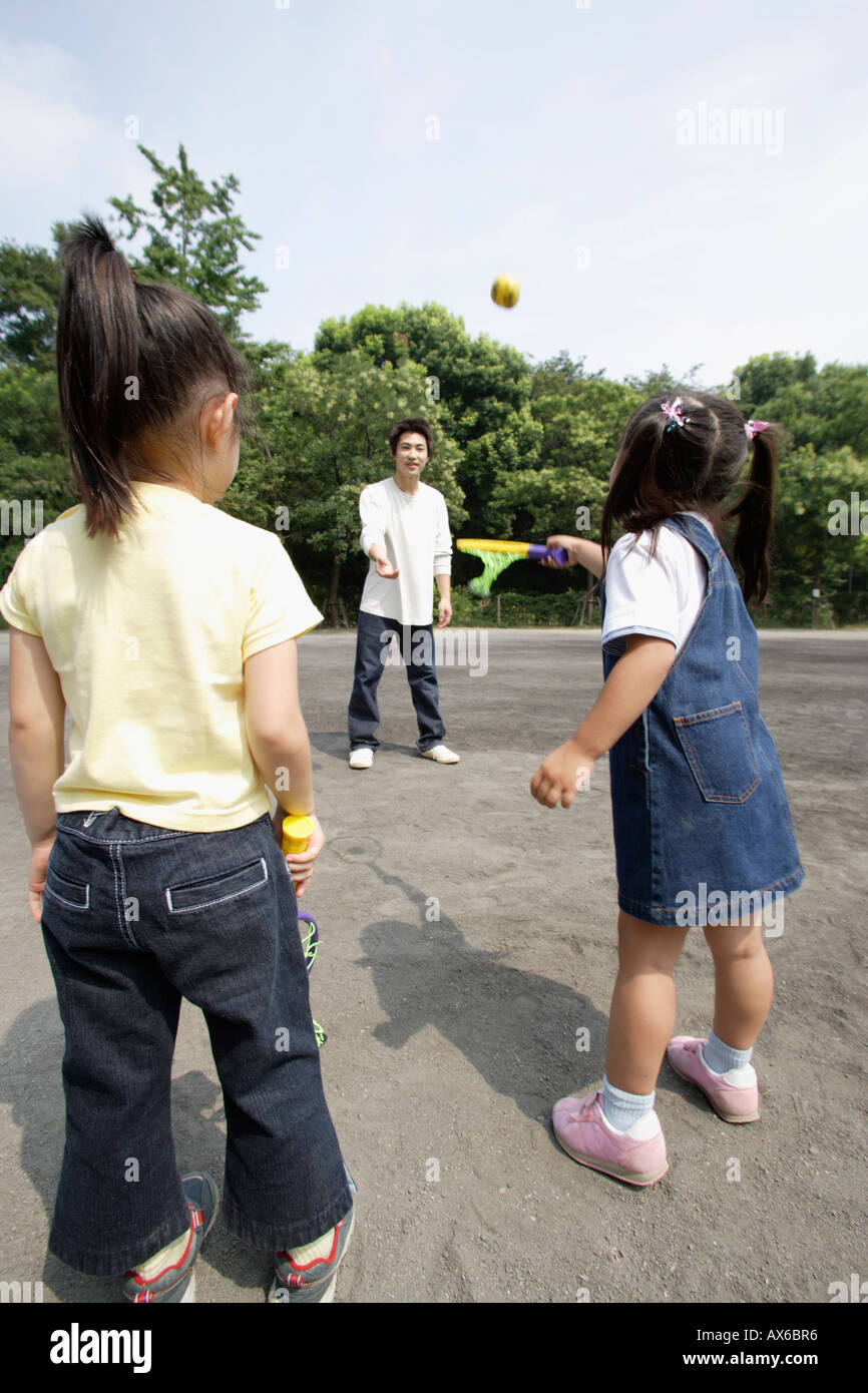 A young father playing catch with daughters Stock Photo - Alamy