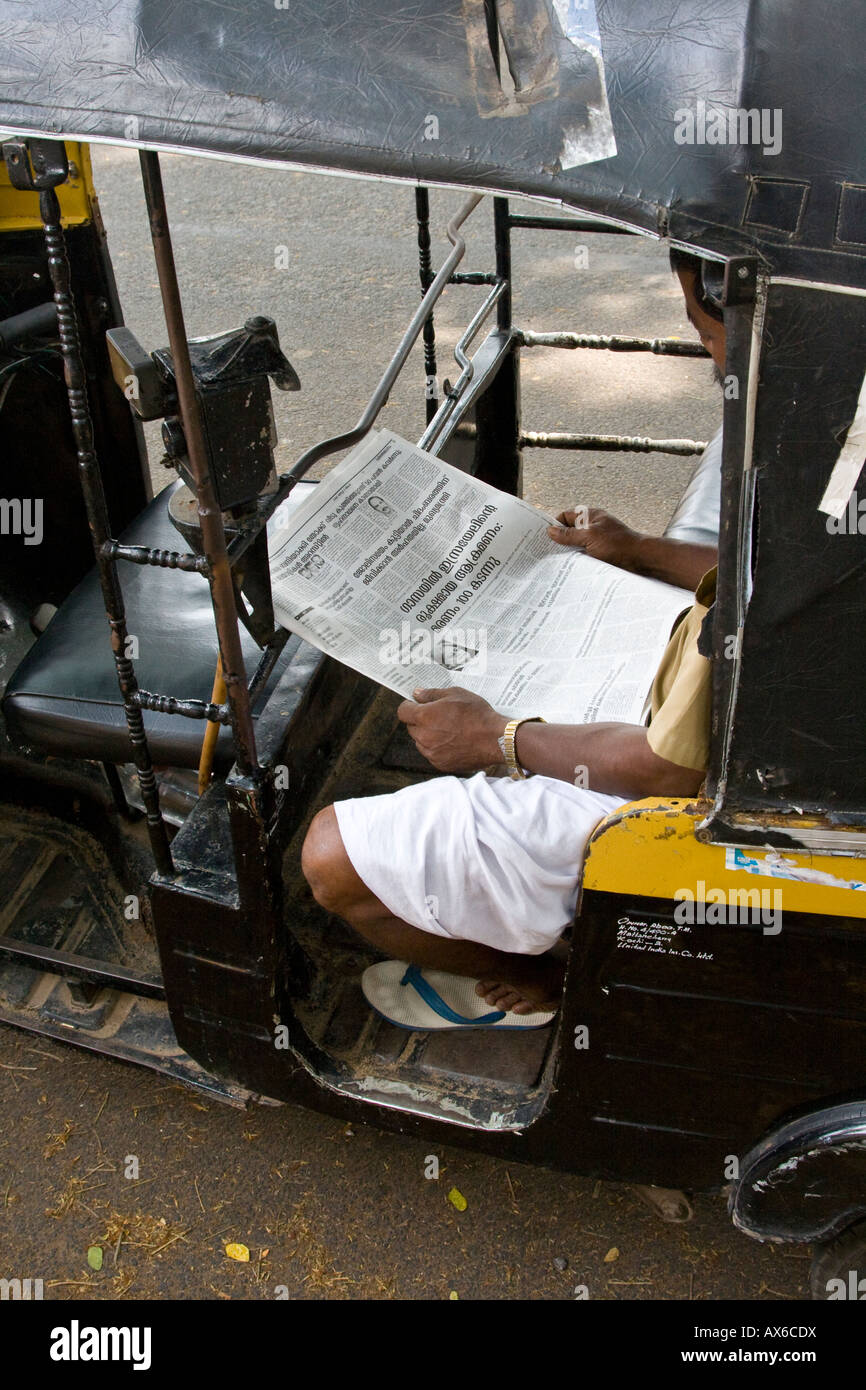 Autorickshaw Driver Reading a Newspaper in Cochin India Stock Photo - Alamy