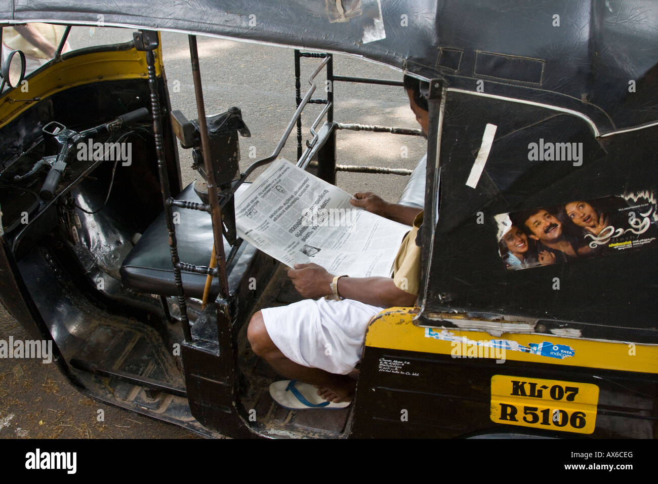 Autorickshaw Driver Reading a Newspaper in Cochin India Stock Photo - Alamy