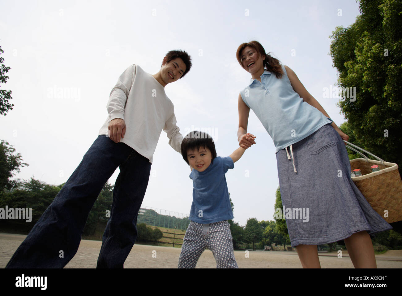 A boy standing between mother and father Stock Photo - Alamy