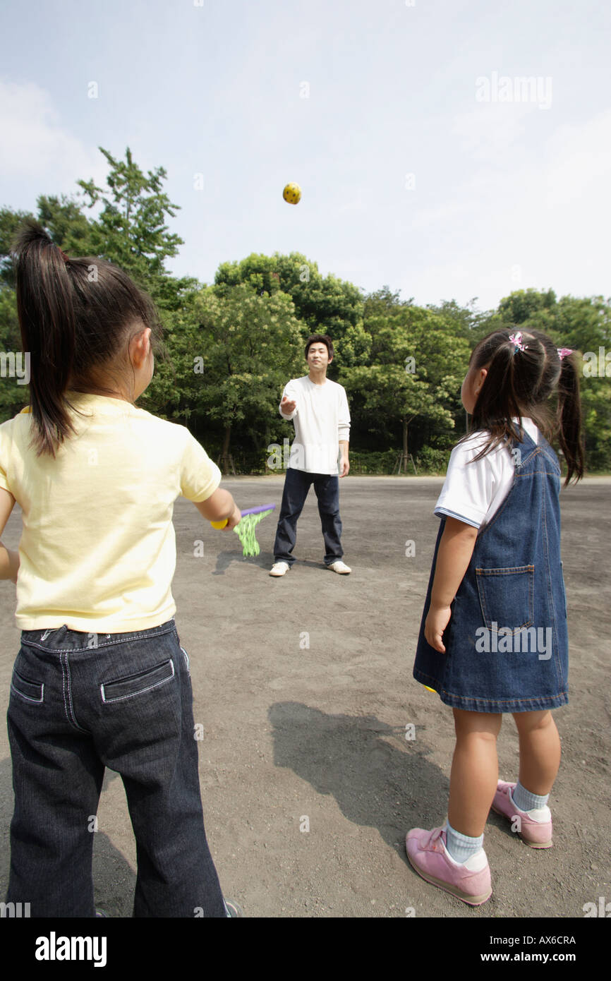 Two girls playing catch with father Stock Photo - Alamy Two girls playing catch with father Stock Photo - Alamy