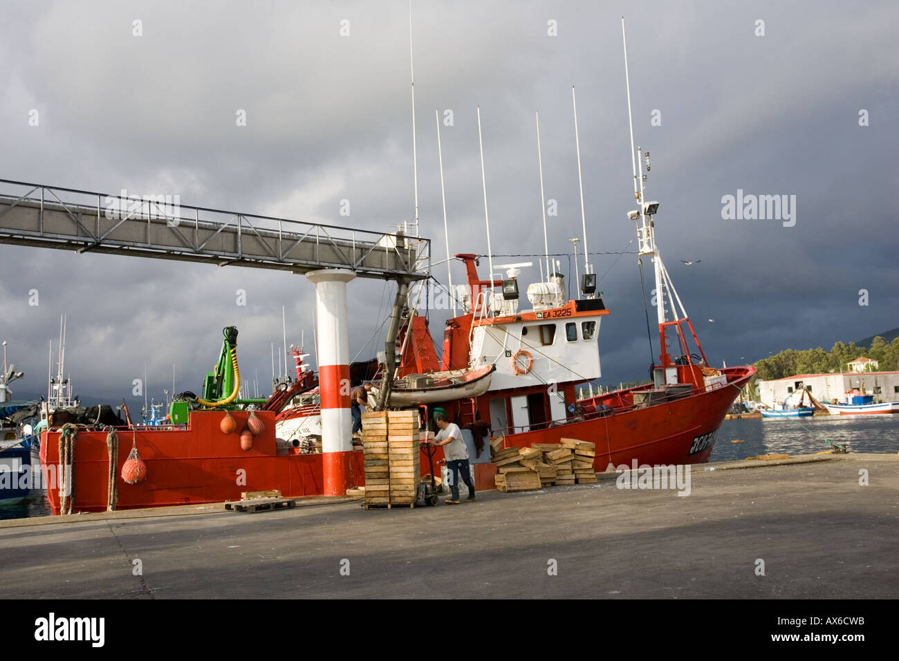 Loading ice into trawler in harbour Porto de Son Rias Baixas Western ...