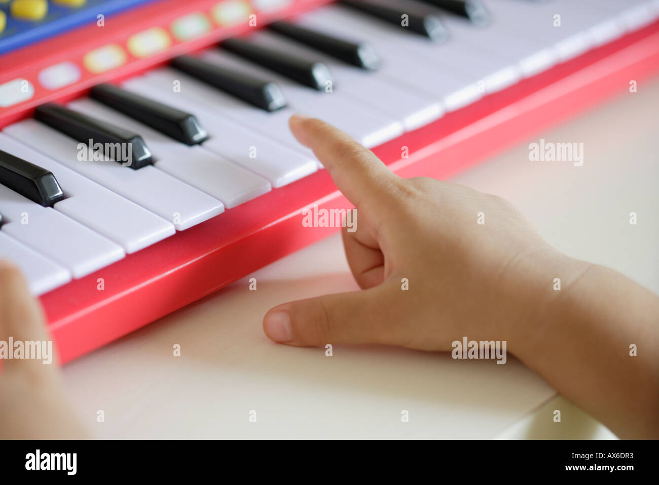A child playing a toy organ Stock Photo - Alamy