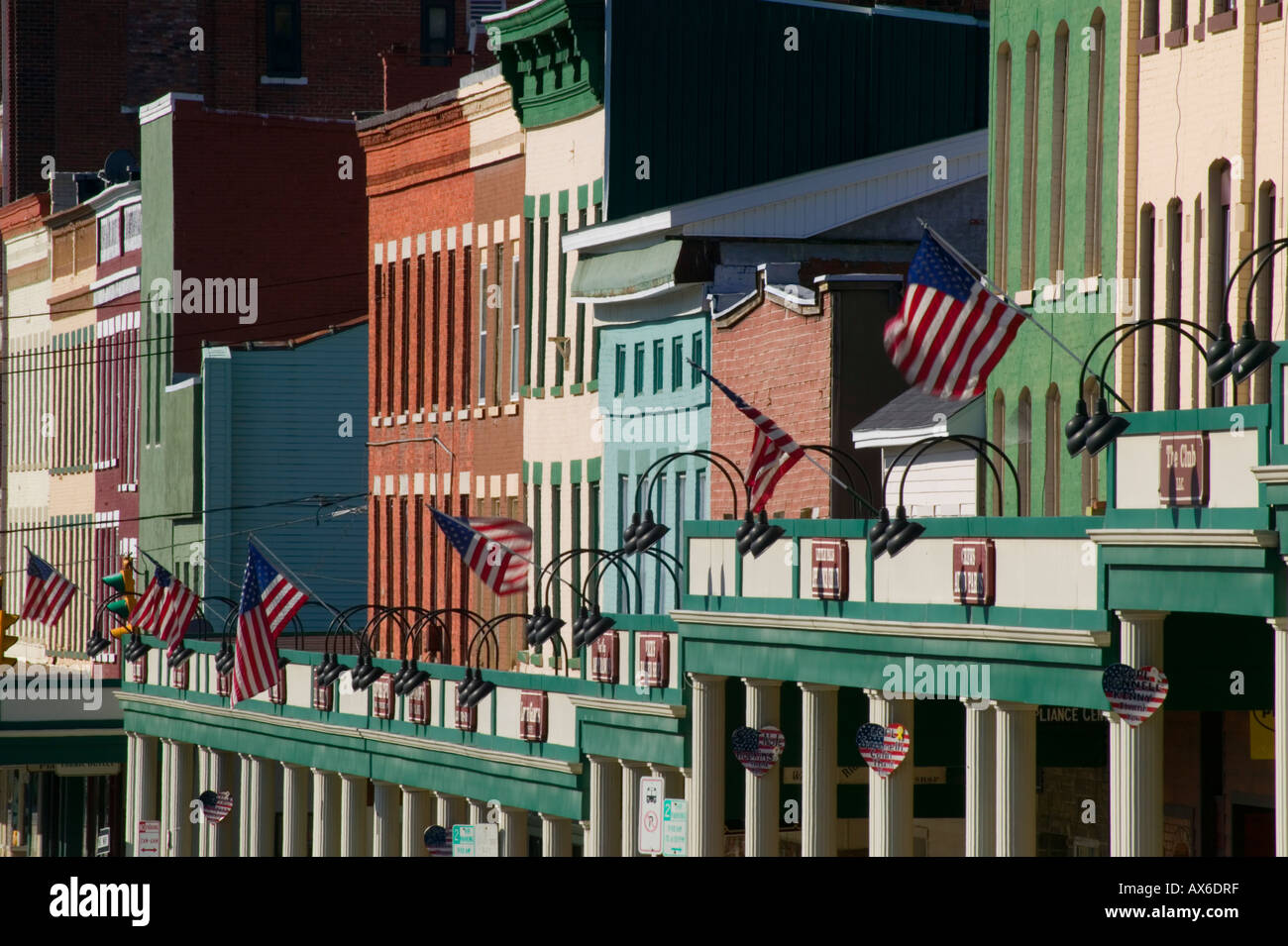 Historic building facades with portico and flags in the Erie Canal town ...