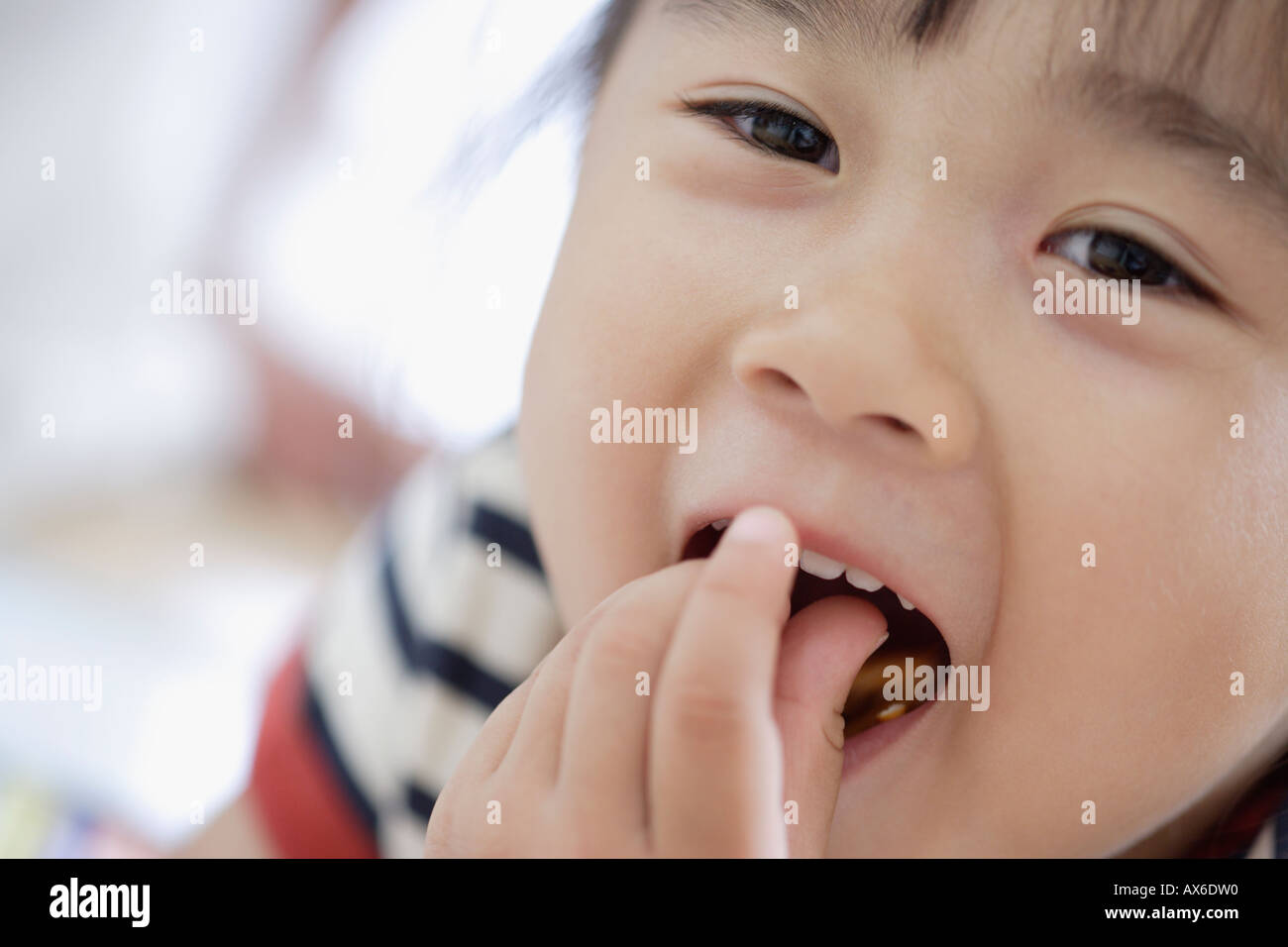 A girl munching Stock Photo - Alamy