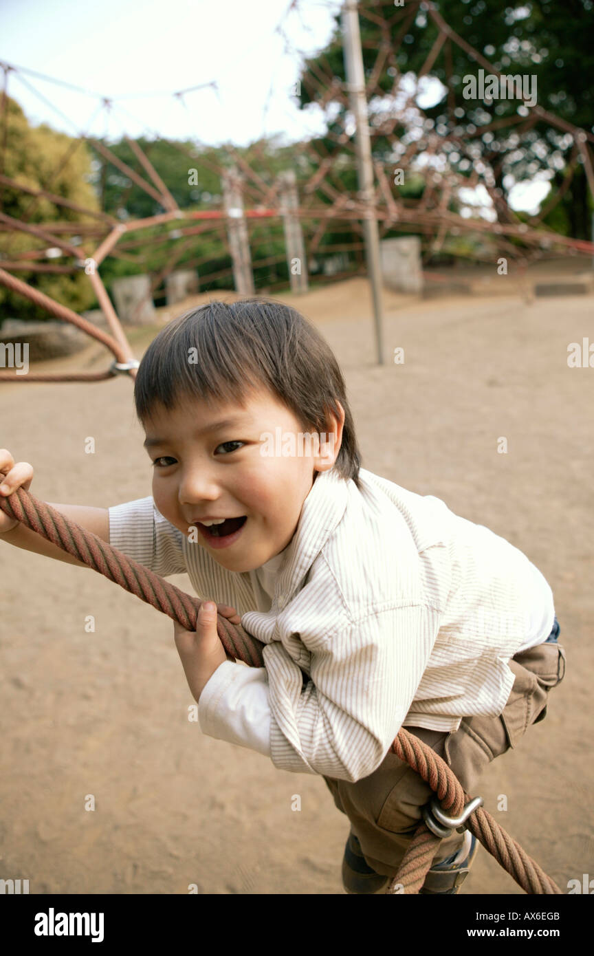 Boy swinging on garden rope hi-res stock photography and images - Alamy
