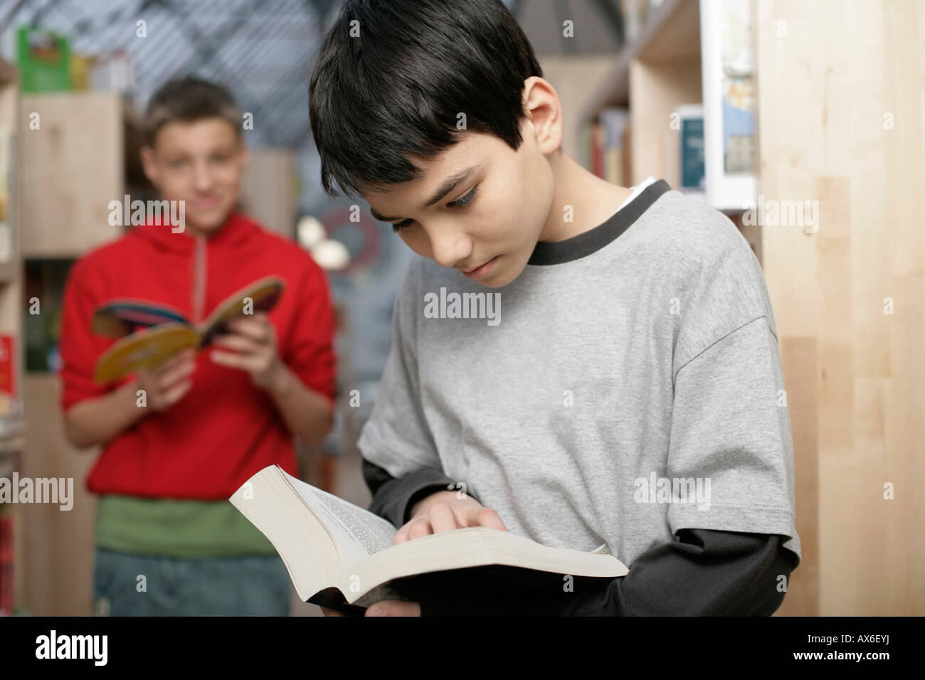 Two boys reading, fully released Stock Photo - Alamy