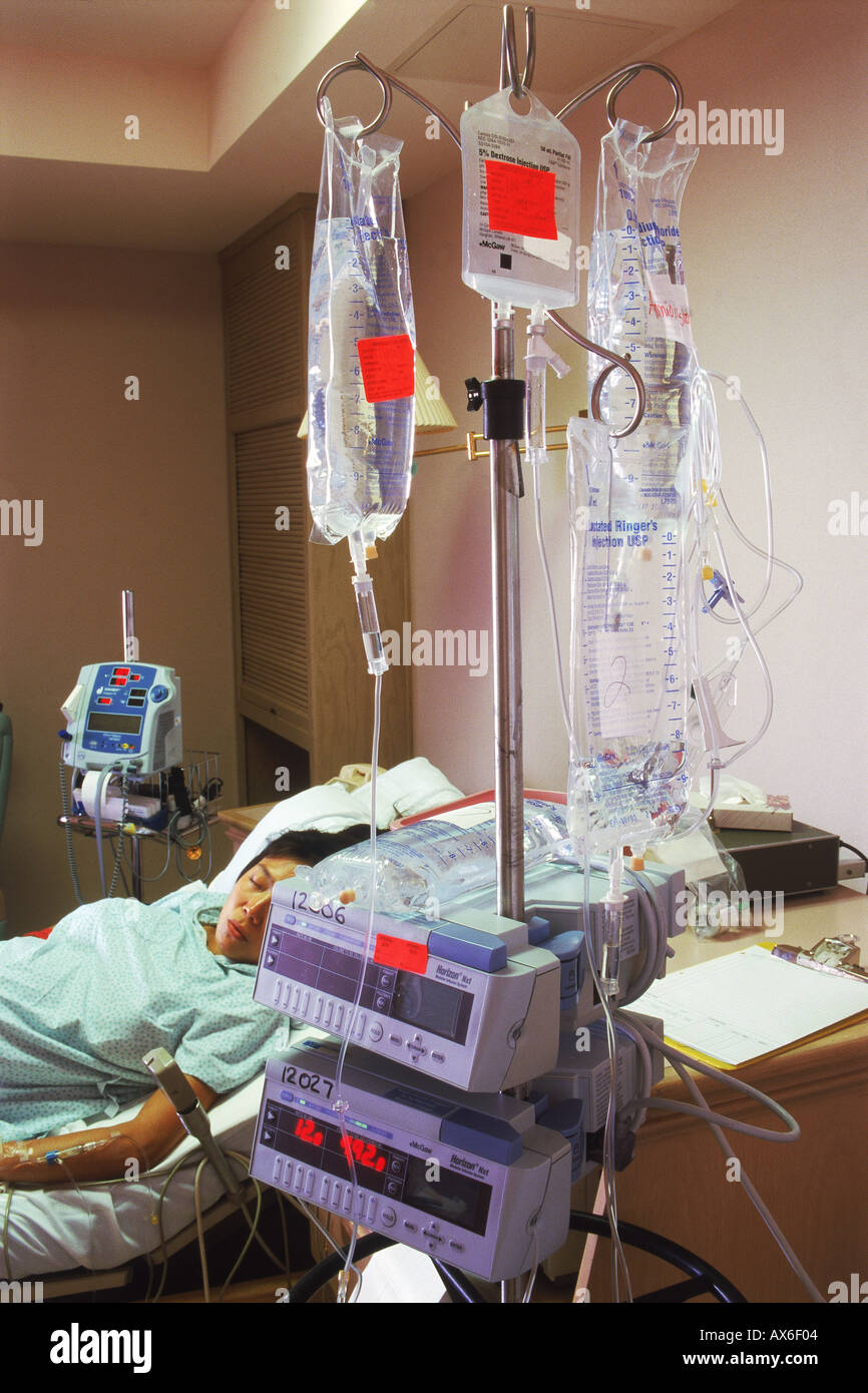 Woman connected to IV tubes in hospital recovery room Stock Photo - Alamy