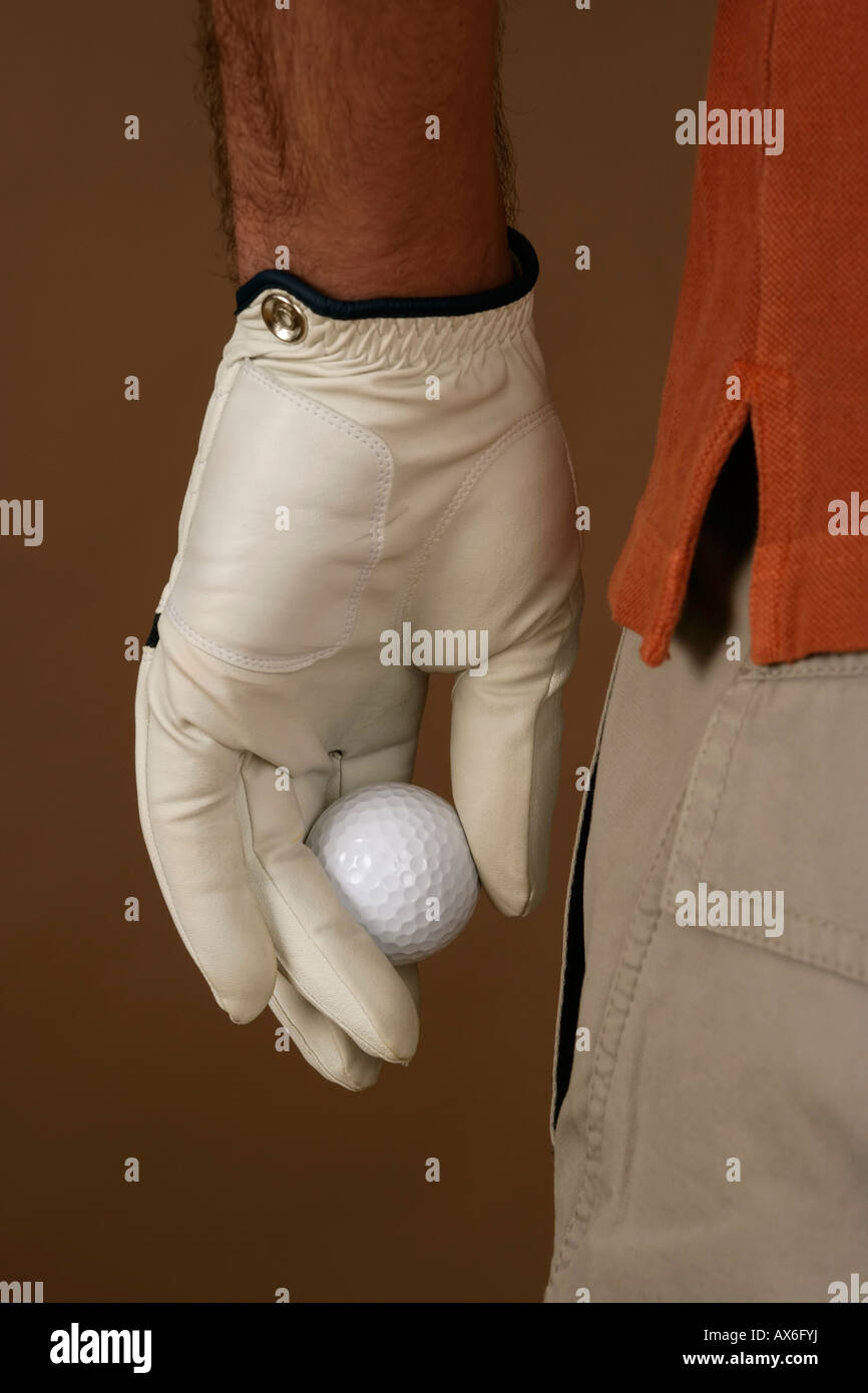 A golf player holding golf balls in his hand Stock Photo - Alamy