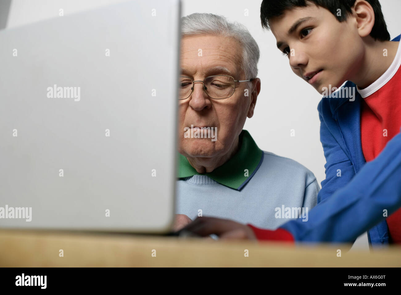 Grandfather and boy using a laptop, fully released Stock Photo - Alamy