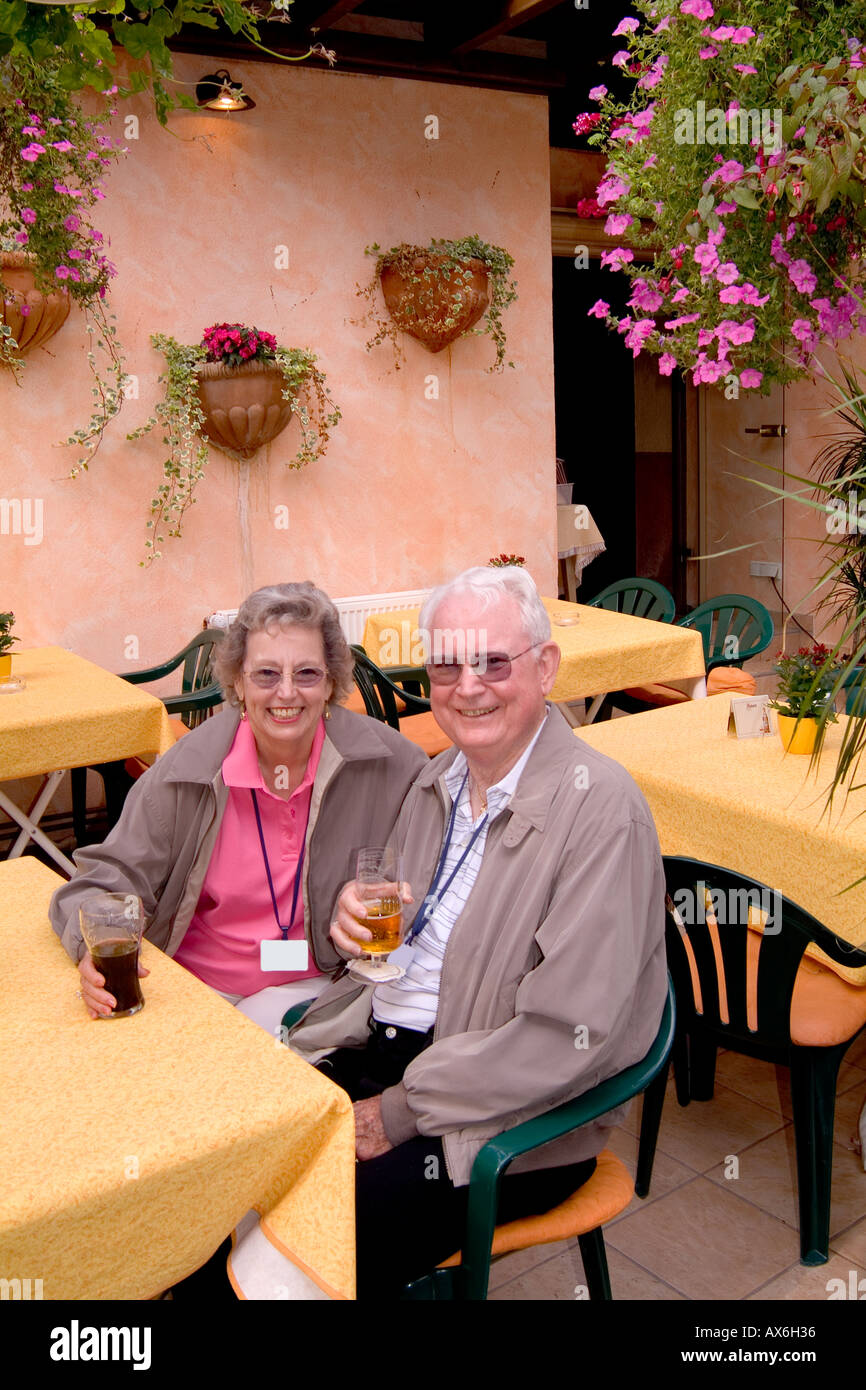 Retired couple vacationing in Germany at German Restaurant having wine ...