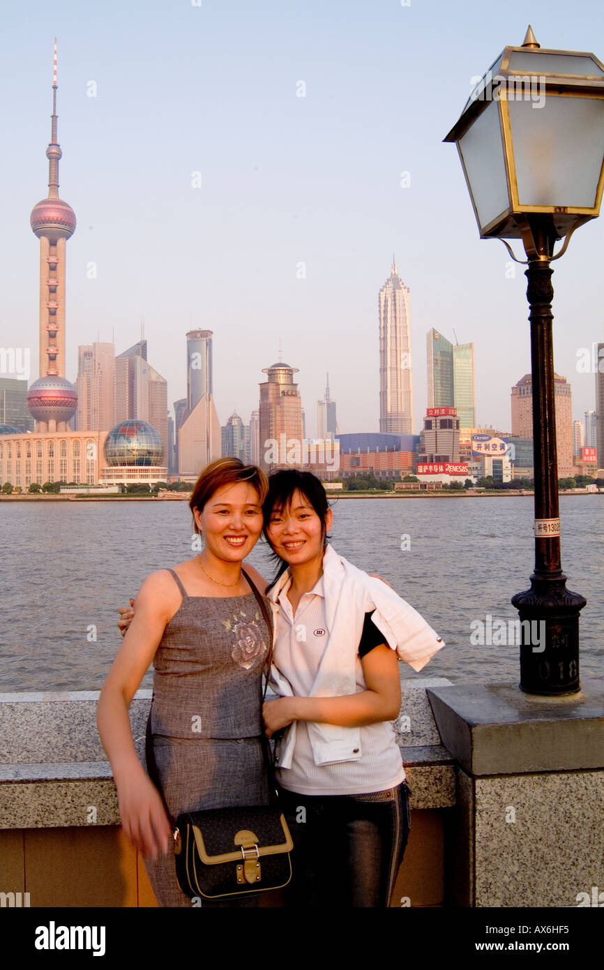 Shanghai China two Chinese women with modern skyscrapers by river at ...