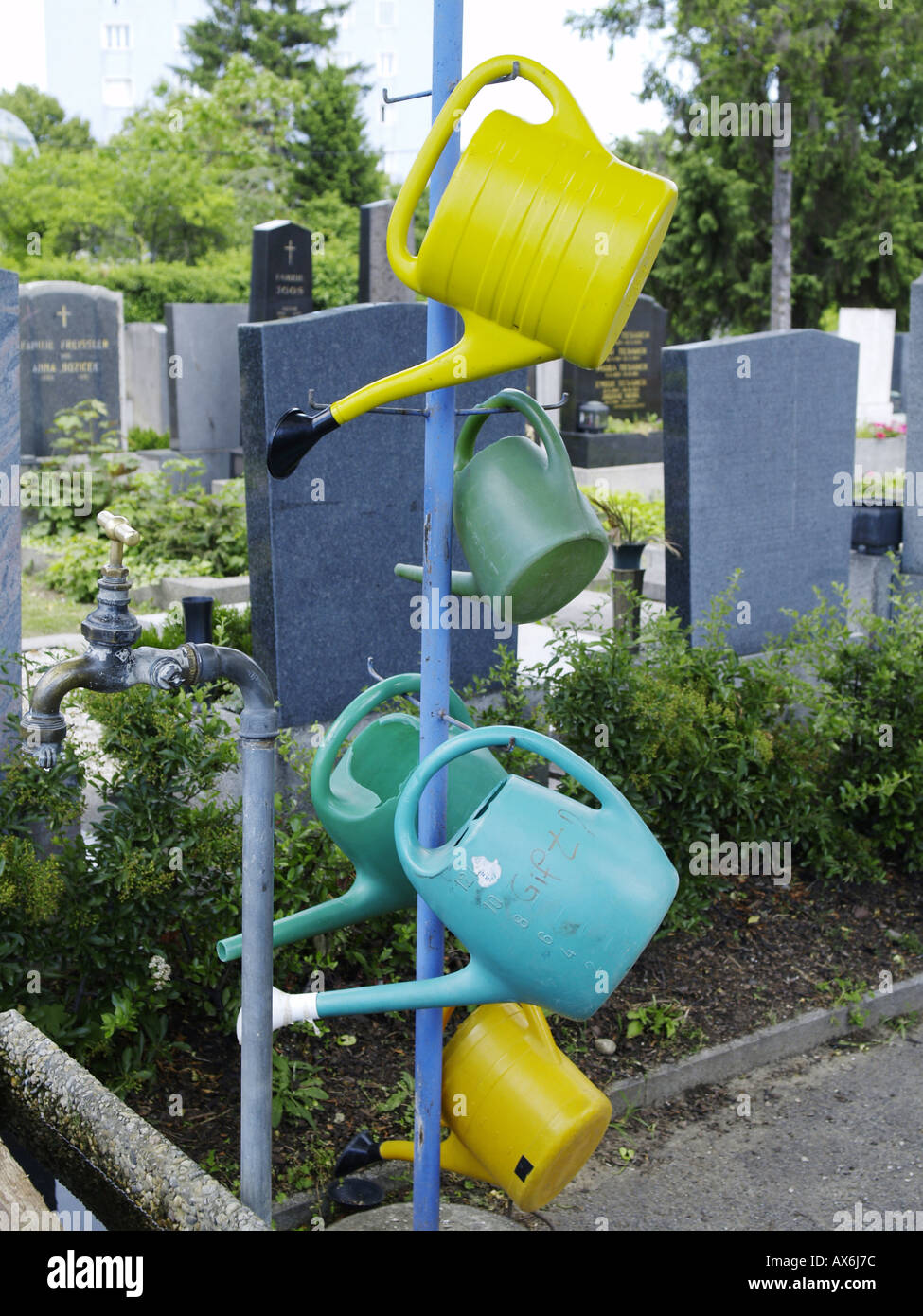 watering cans at cemetery Stock Photo - Alamy
