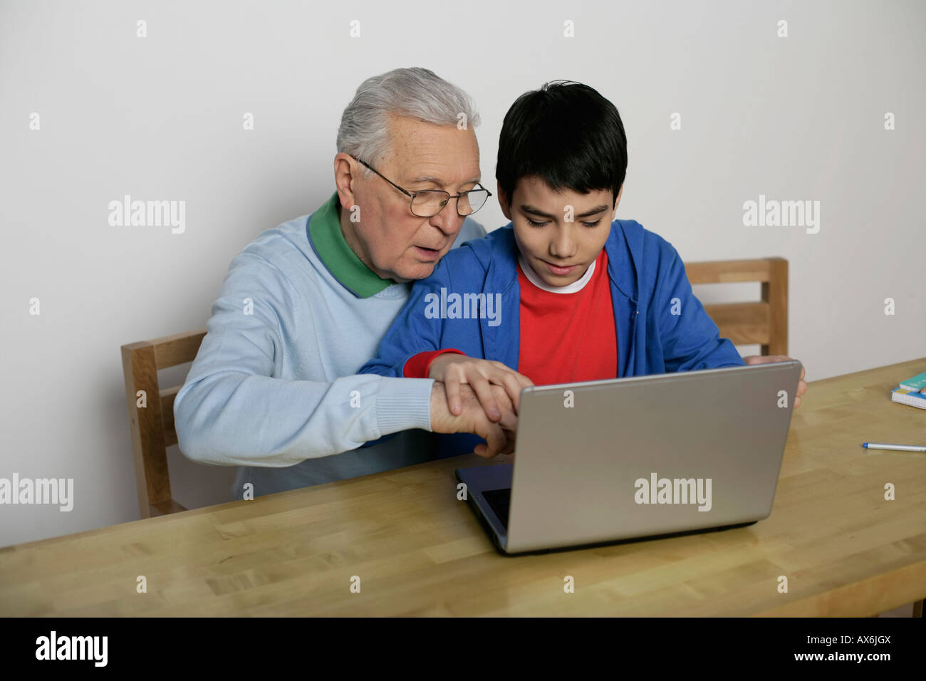 Grandfather and boy using a laptop, fully released Stock Photo - Alamy