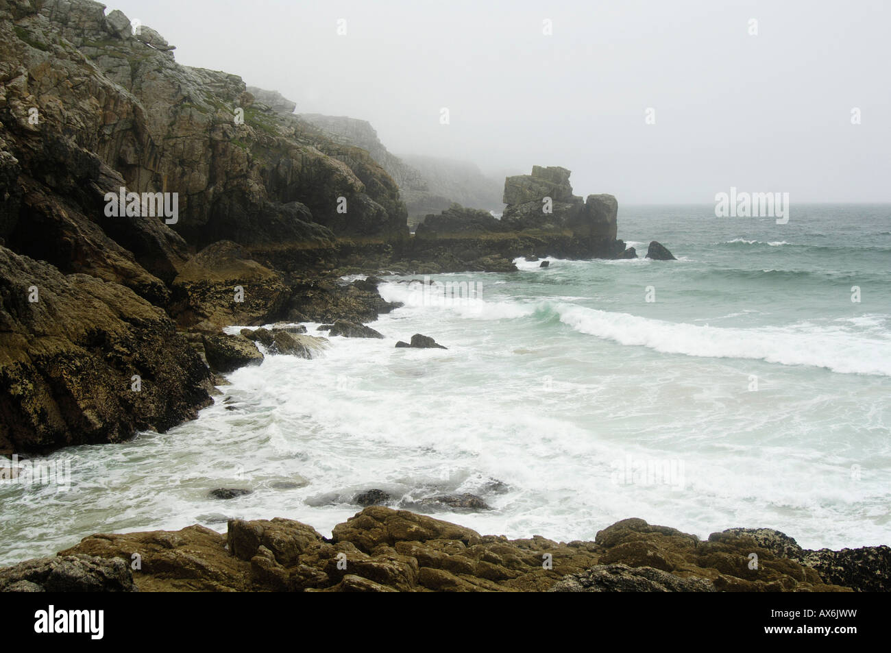 Waves breaking against rocks Stock Photo - Alamy