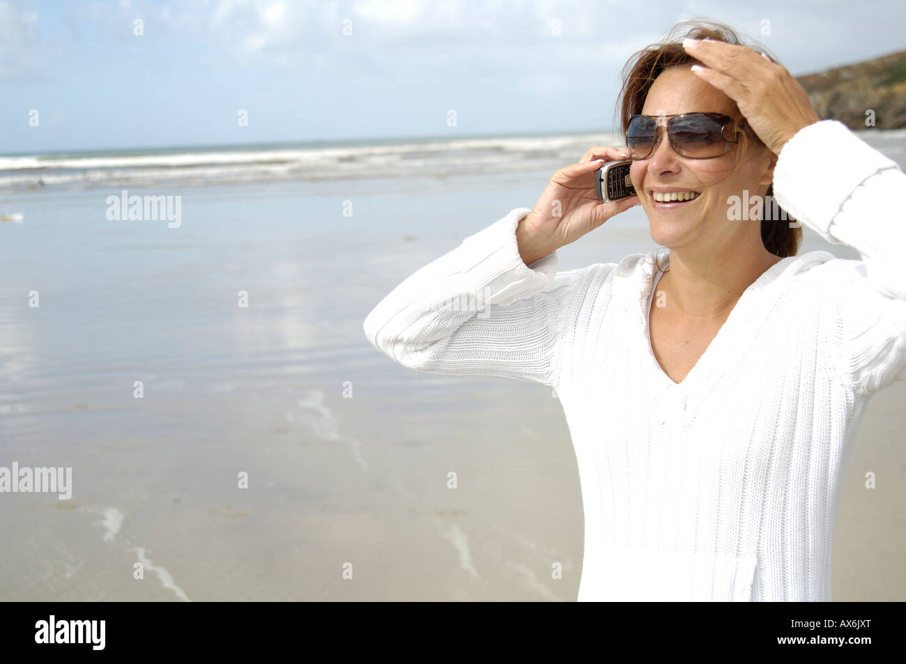 Close-up of woman talking on mobile phone on the beach Stock Photo - Alamy
