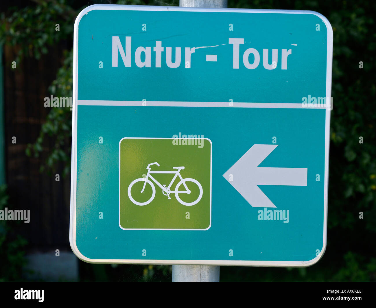 sign cycle track, Natur-Tour, arrow to the left Stock Photo - Alamy
