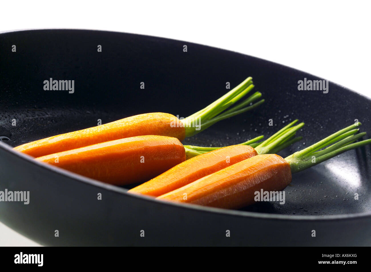 four carrots in a pan, elevated view Stock Photo - Alamy
