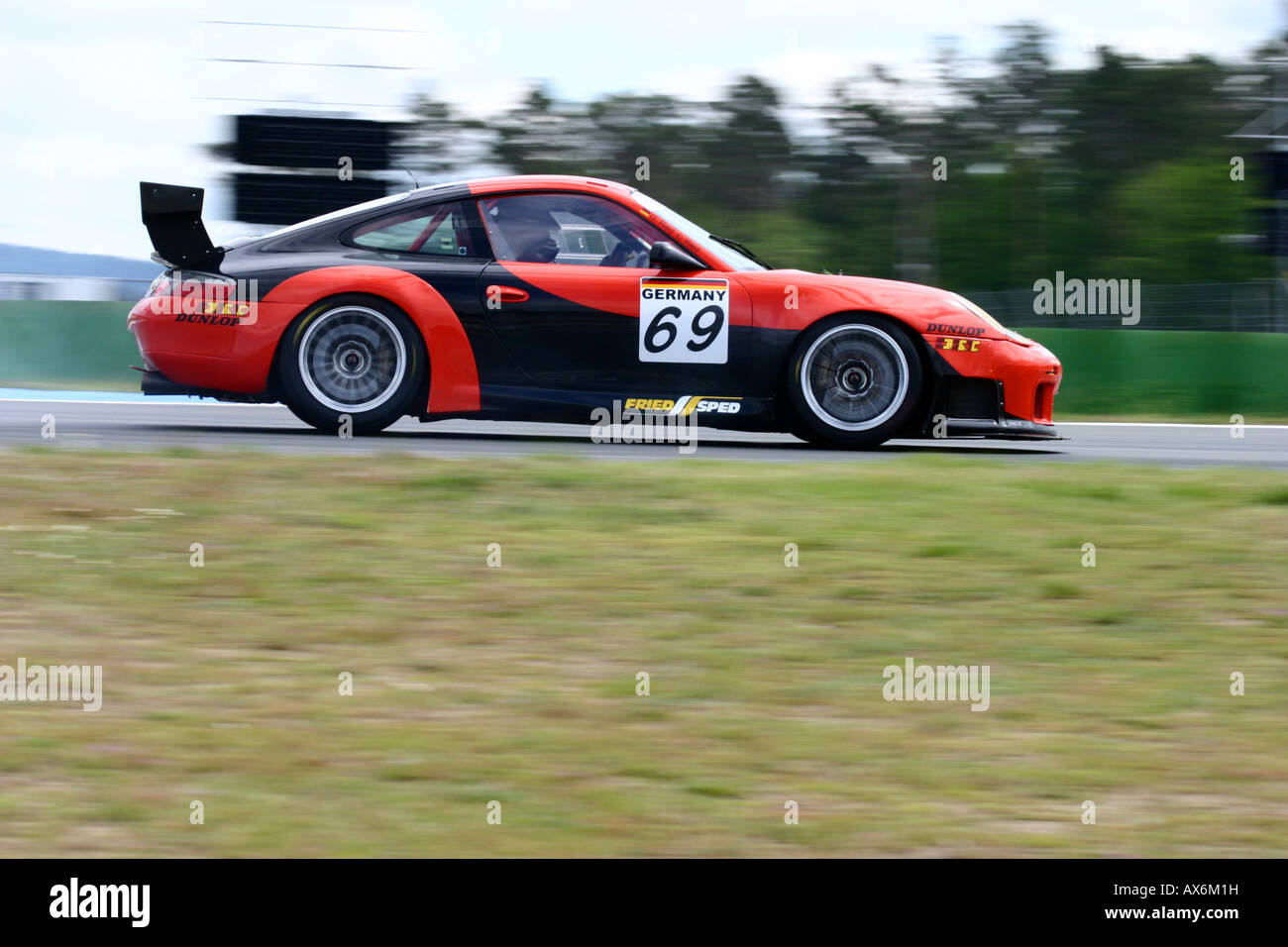 Sports car moving on track Stock Photo - Alamy