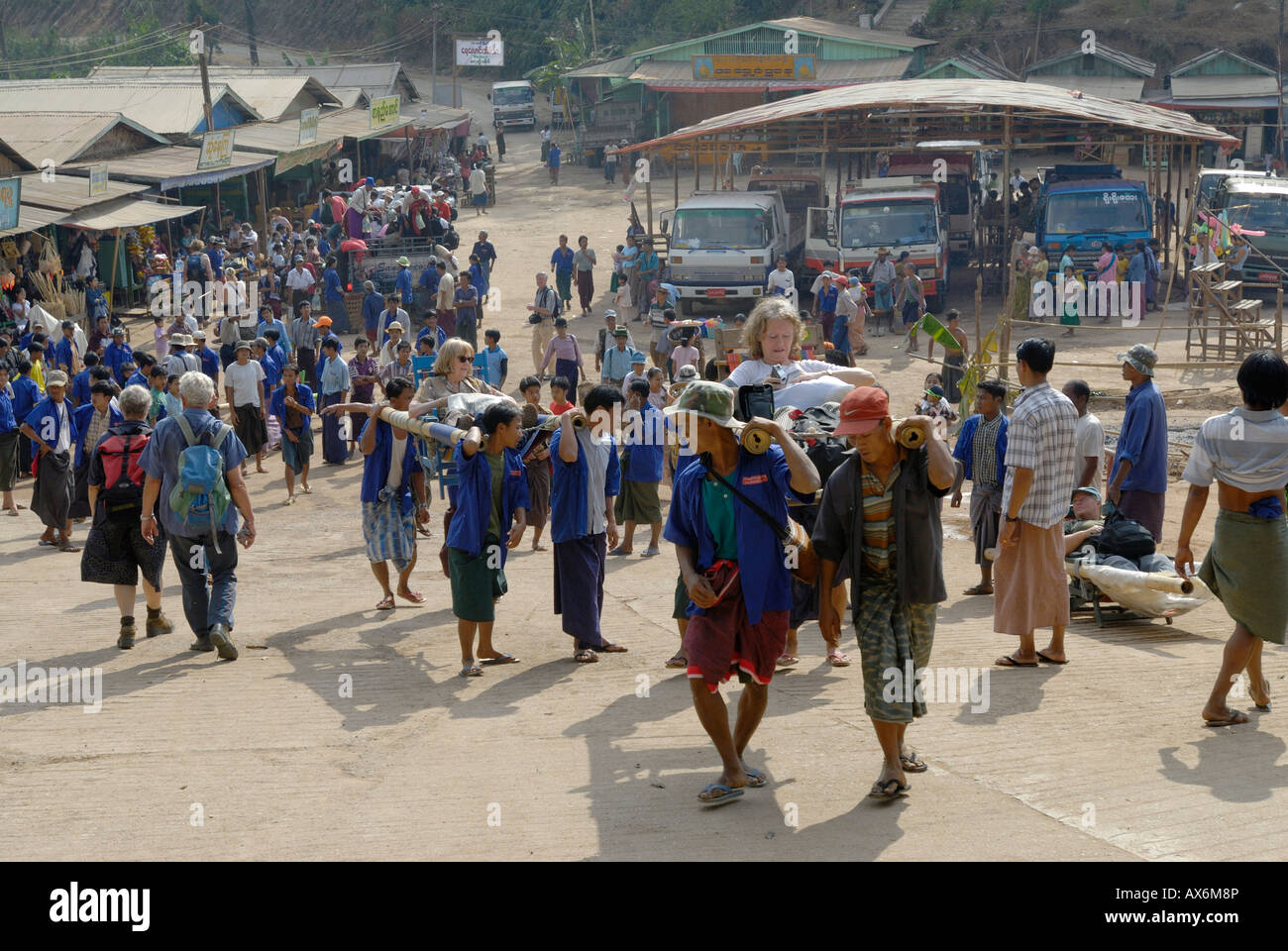 People carrying tourists on sedan chairs Kinpun Base Camp Myanmar Stock ...