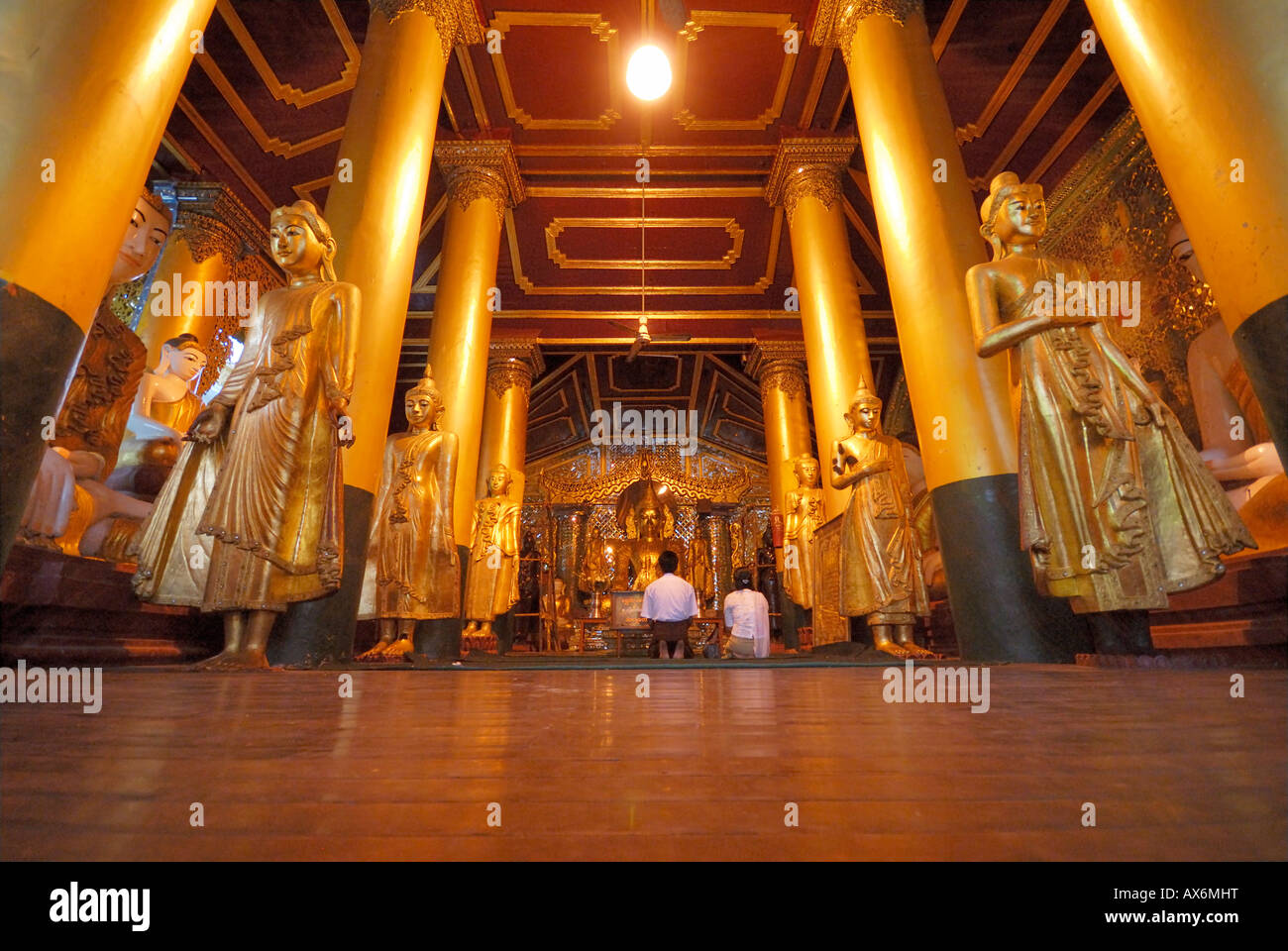 Two devotees inside Buddhist temple Shwedagon Pagoda Yangon Myanmar ...