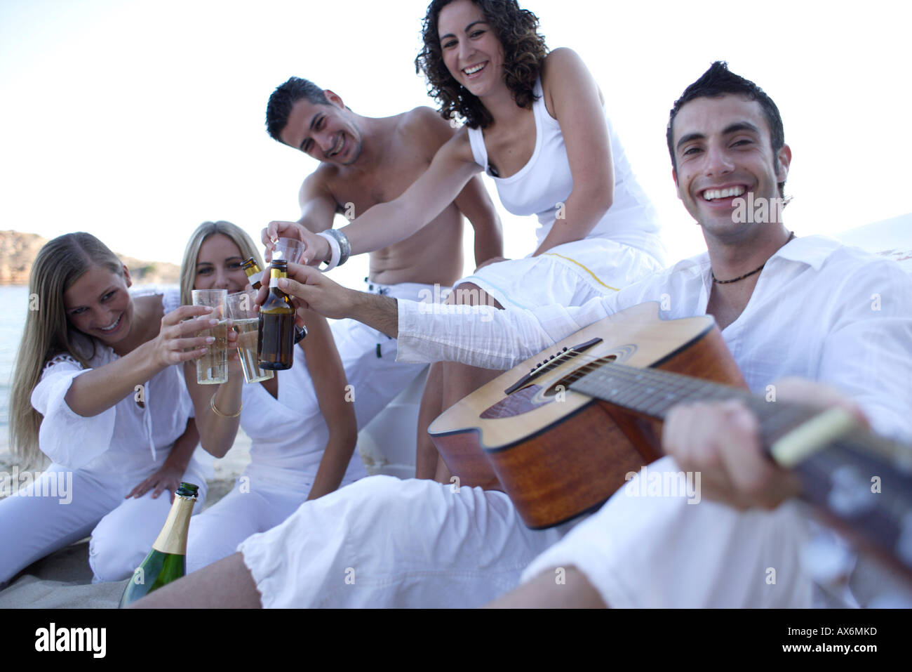 Group of young people at beach party, Mallorca Stock Photo - Alamy